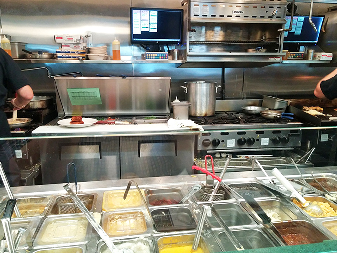 The open kitchen reveals the secret ingredient – a well-organized team turning ordinary ingredients into extraordinary comfort food.