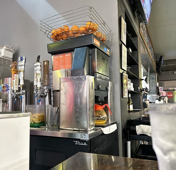 Fresh-squeezed orange juice machine standing at attention. Because proper breakfast deserves proper juice—no cartons allowed in this temple of morning meals.