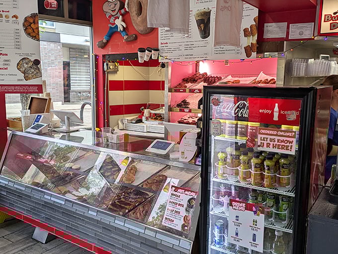 The donut command center—where magic happens behind glass cases filled with frosted, glazed, and cream-filled treasures waiting for their forever homes.