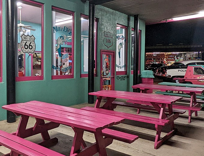 Pink picnic tables outside Mr. D'z don't just offer seating—they provide front-row tickets to the greatest show on Route 66.