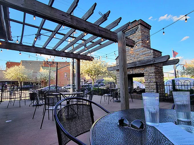 The outdoor patio offers string lights, pergola shade, and a stone fireplace—a trifecta of al fresco dining perfection. You'll forget you're in Ohio, not Tuscany.