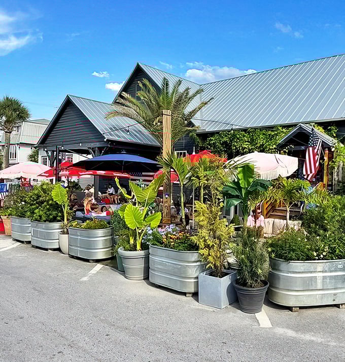 The lush outdoor area feels like a secret tropical garden. Those metal tubs of plants create a natural barrier between you and the real world.