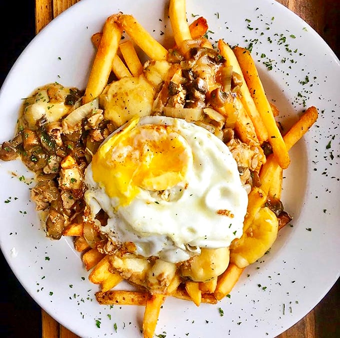 Fries topped with savory gravy, cheese curds, and a perfectly fried egg—proof that sometimes more really is more.