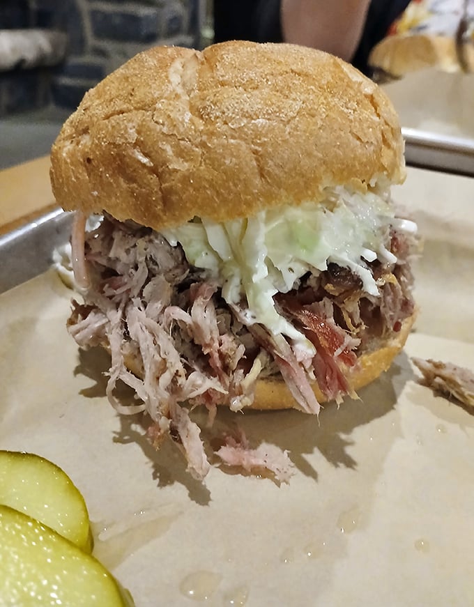 A pulled pork sandwich that doesn't just satisfy hunger—it resolves existential questions about the meaning of lunch.