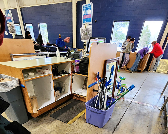The checkout area—final frontier before treasures officially change hands. Those canes and children's toys represent the democratic nature of thrift discoveries.
