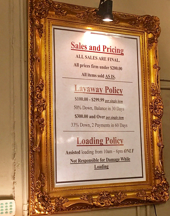 The policies are displayed with vintage flair – where else would payment terms come framed in something worthy of Versailles?