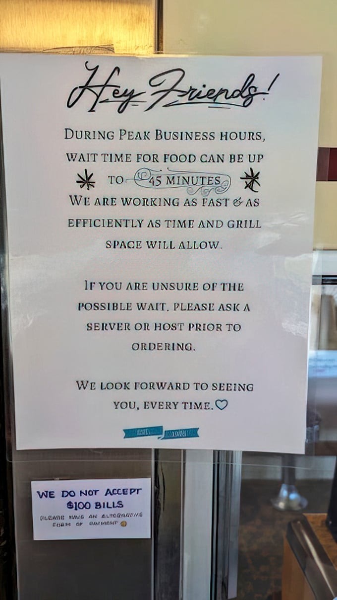 A friendly reminder that good things take time—a sign that speaks volumes about the care behind every plate that emerges from the kitchen.