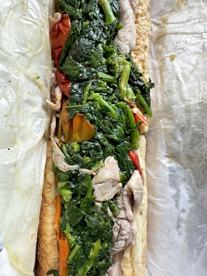 The legendary roast pork with broccoli rabe—Philly's other sandwich superstar. That glistening green vegetable cuts through richness like nature's perfect counterpoint.