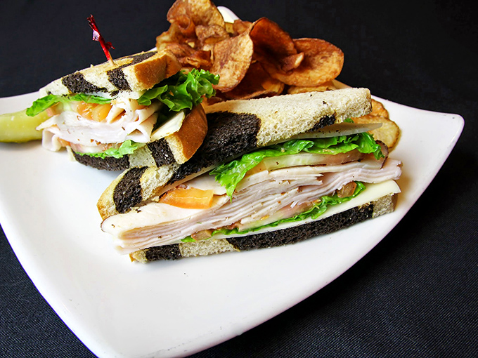 The club sandwich—boxing's unsung middleweight champion. Layers of flavor stacked higher than a fighter's ambitions, with house-made chips as the perfect cornerman.