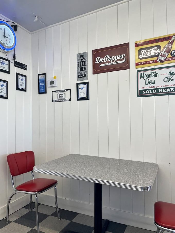 These vintage tables and soda signs aren't decoration—they're time machines to when a burger joint was the center of a community's universe.