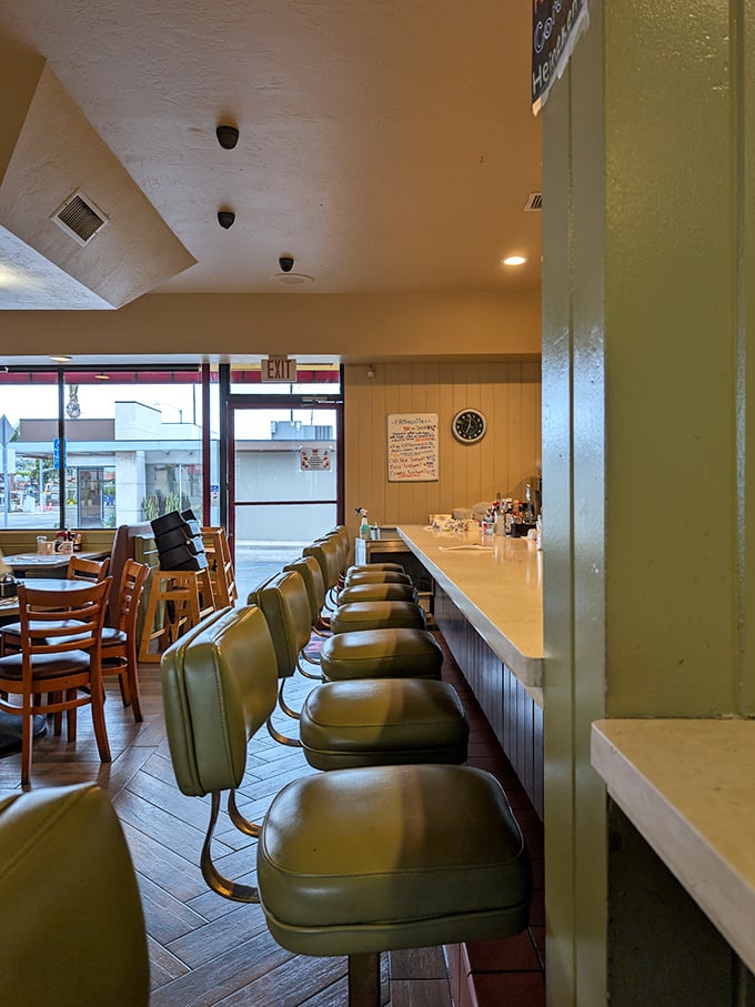 The counter seats—where solo diners become regulars, servers become therapists, and you can watch short-order magic happen in real time.