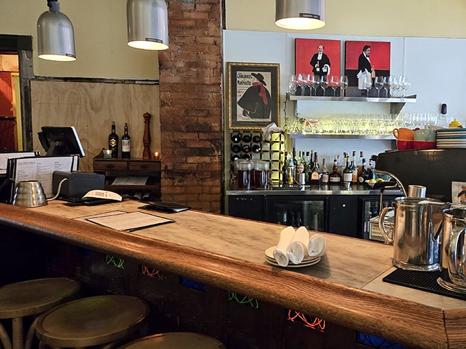 Behind the wooden bar, French posters and gleaming glassware create the backdrop for cocktail magic and coffee alchemy.