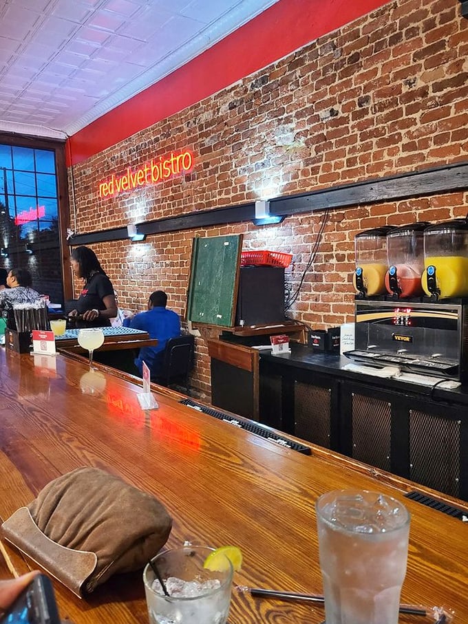 The bar area—where exposed brick, polished wood, and the promise of good drinks create the perfect backdrop for your food adventures.