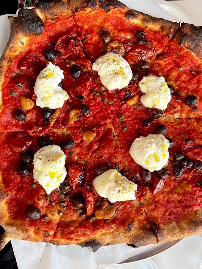 She Wolf brings burrata and garlic confit together in holy pizza matrimony – bellissimo!