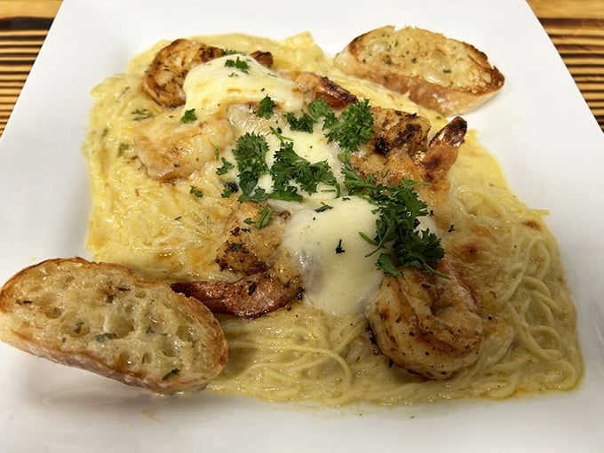 Shrimp and pasta swimming in a sauce so rich it should have its own tax bracket. Those garlic toast points aren't just garnish—they're essential tools.