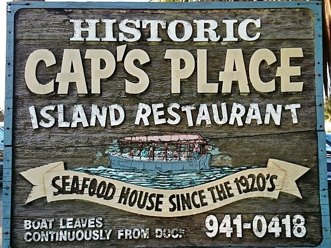 The sign says it all—historic, island-bound, and accessible only by boat. Some restaurants try to create character; Cap's Place simply has it.