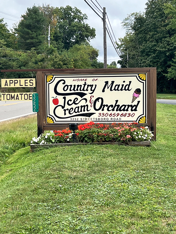 The roadside sign blooming with flowers—nature's way of highlighting the sweetest detour you'll make all day.
