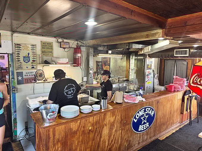 Where burger magic happens. The open kitchen reveals the choreographed dance of Texas comfort food preparation.