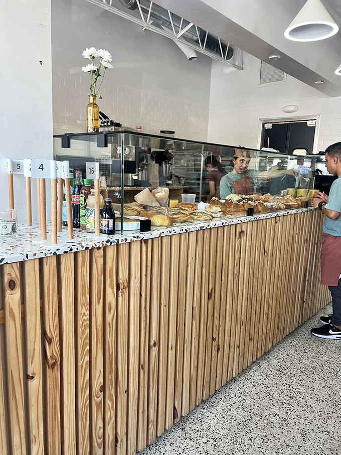 Where the pastry magic happens – the counter staff at Caracas Bakery serving up Venezuelan delights with the efficiency of people who know they're changing lives.