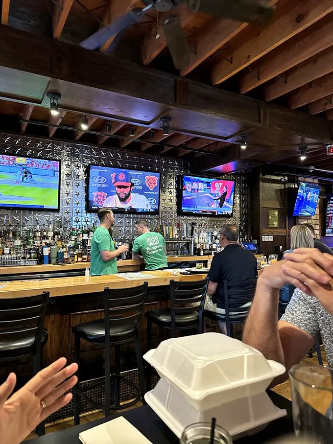 The bar area buzzes with energy—where strangers become friends over craft beers and the shared religion of Chicago sports.