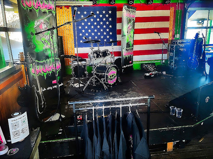 The stage awaits tonight's band, with an American flag backdrop promising that special blend of patriotism and party that defines dock bars.