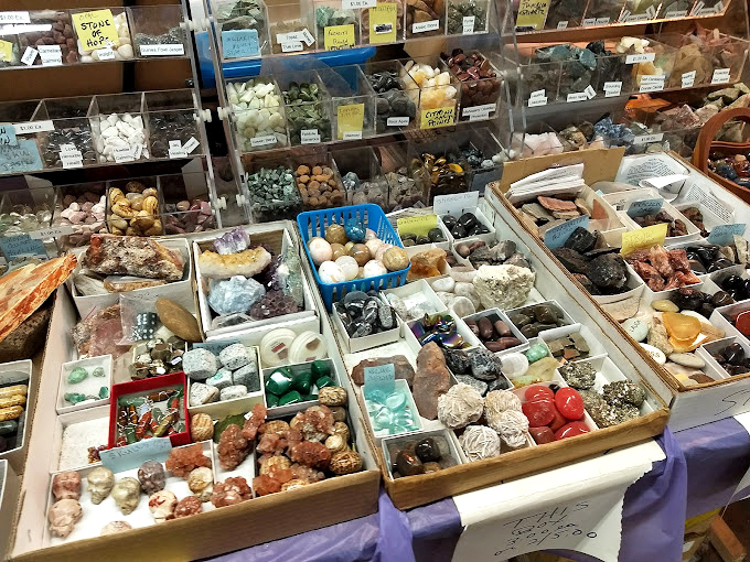 Nature's jewelry box spilled open—crystals, geodes, and polished stones organized with scientific precision. Earth's artwork, millions of years in the making.