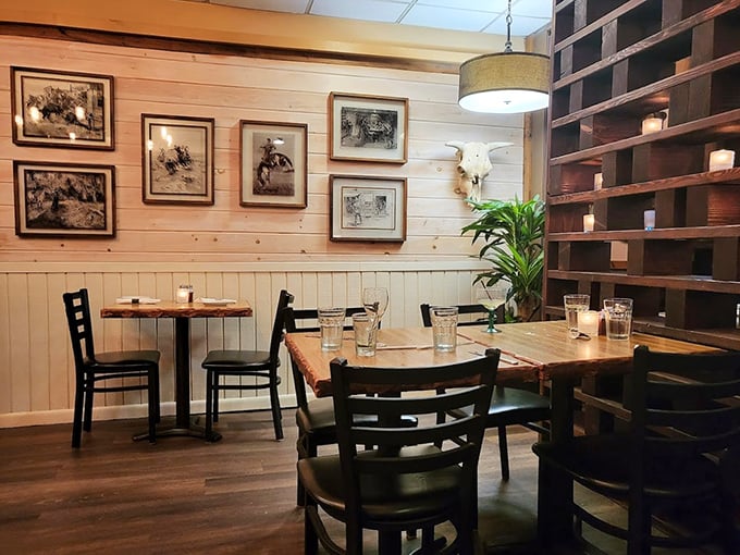 Light wood, Western artwork, and thoughtful spacing create an atmosphere where conversations flow as smoothly as the wine. Notice the candles adding that perfect glow.