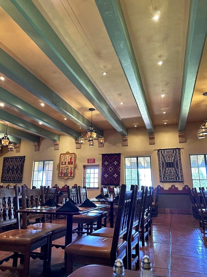 Turquoise ceiling beams and Navajo textiles create a dining space that feels both grand and intimate. Southwest elegance without a hint of pretension.