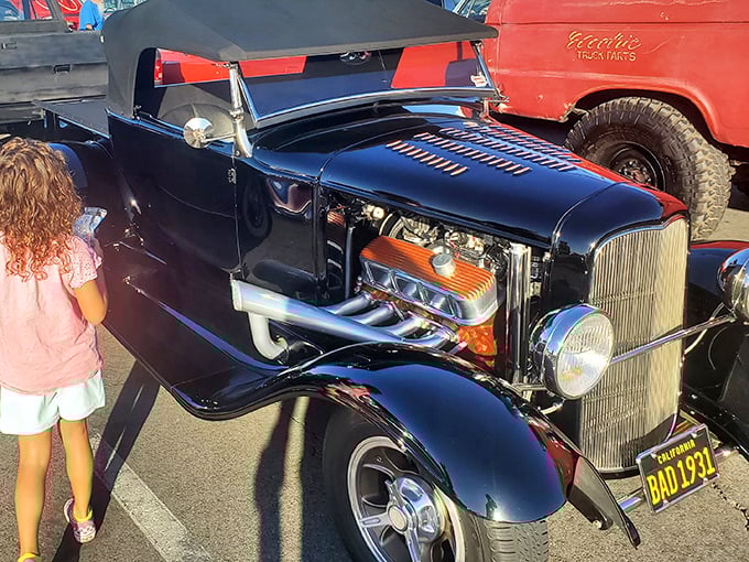 Hot rod perfection meets classic American craftsmanship, chrome gleaming under California's endless blue sky beauty.