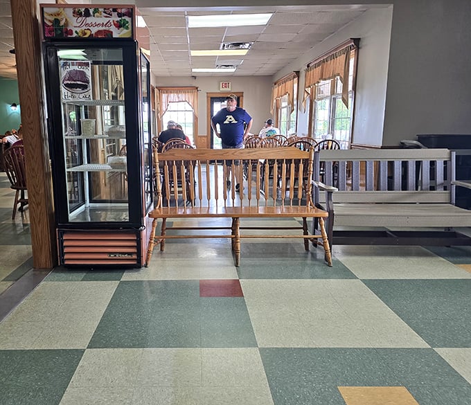 A wooden bench near the dessert case – either the best waiting area ever designed or the cruelest form of sweet temptation.