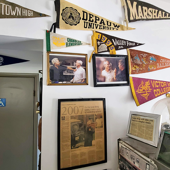 College pennants and newspaper clippings tell stories of community connections. This isn't just decoration—it's a scrapbook on the wall.