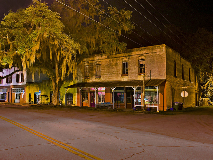 Night falls on Micanopy's vintage storefronts, casting a golden glow that makes this tiny town feel like a movie set.