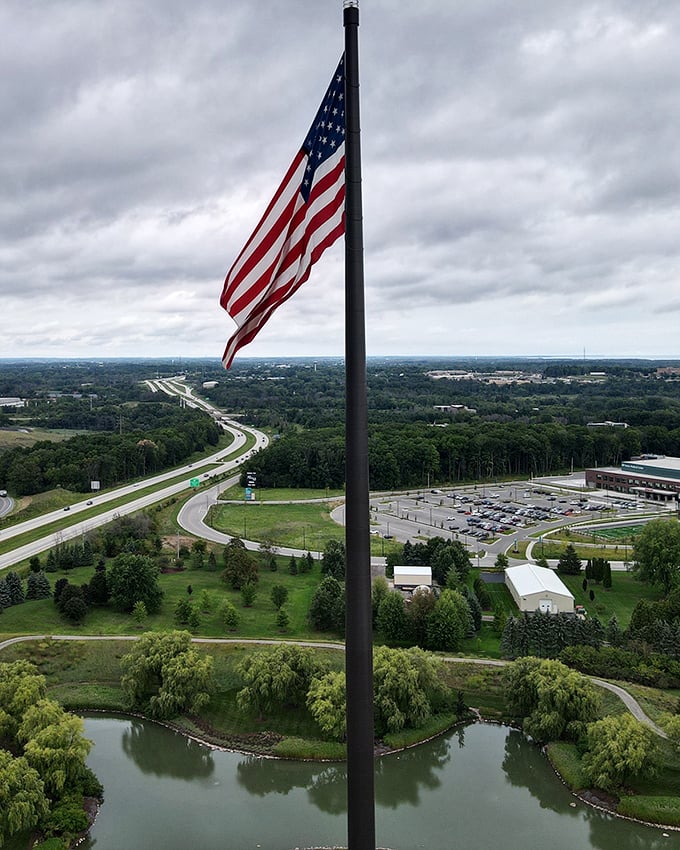 America's tallest flagpole stands sentinel over Sheboygan, a 400-foot exclamation point declaring Midwestern pride against dramatic skies.