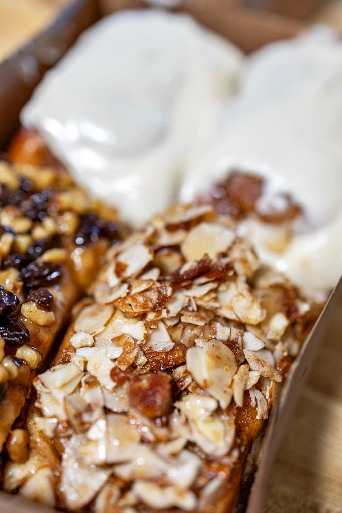 The almond roll—nature's perfect partnership. Toasted almonds add textural contrast and nutty depth to the pillowy sweetness beneath.