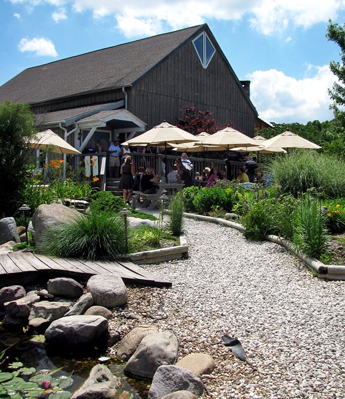 Gardens and stonework create a tranquil approach to the vineyard—like walking through a magazine spread on "places that make you forget your problems."