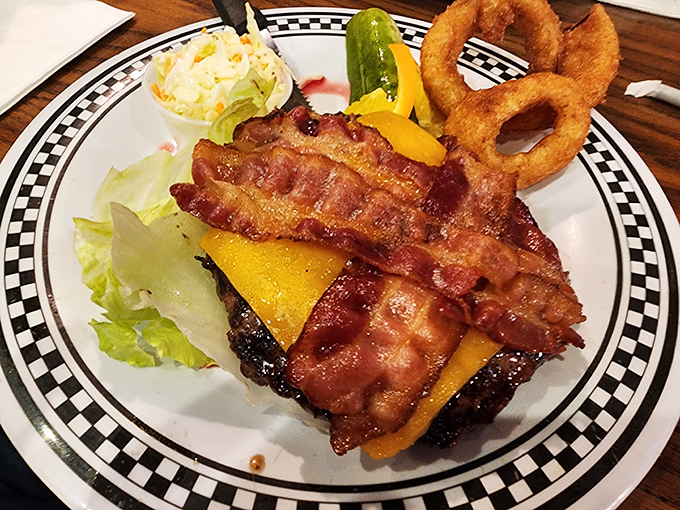 A burger that doesn't just satisfy hunger—it conquers it with crispy bacon reinforcements and melty cheese artillery.