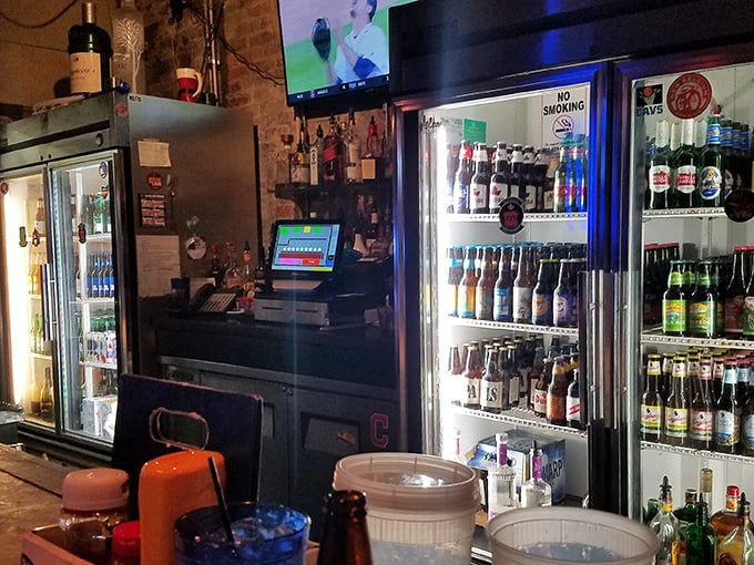 The bar area—where magic happens one pour at a time. That impressive beer selection proves they care about what goes in your glass as much as on your plate.