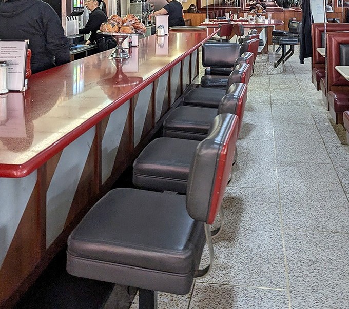 Counter seating: where regulars become family and servers remember your order before you sit down. Diner diplomacy happens one stool at a time.