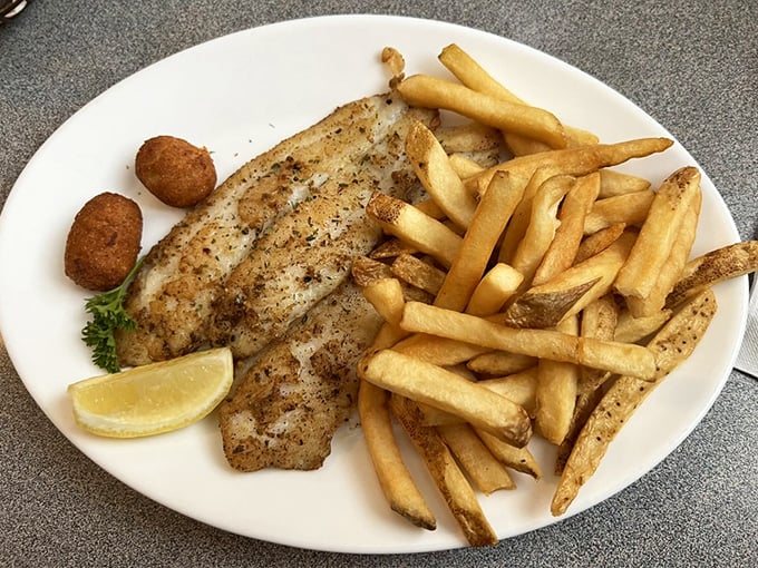 Perfectly grilled fish with golden fries and hush puppies—the holy trinity of Southern seafood dining that makes diets weep with jealousy.