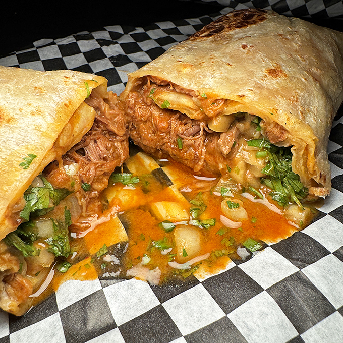 This birria burrito isn't just leaking juice—it's weeping tears of joy that you've finally found each other. Grab extra napkins.