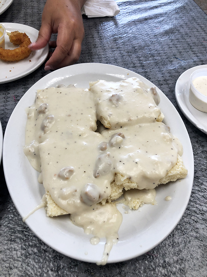 Biscuits and gravy that don't mess around – the gravy blankets those biscuits like it's trying to tuck them in for a delicious nap.