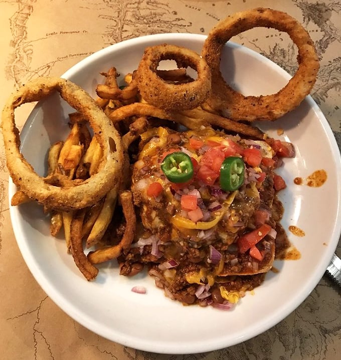 Bison chili nachos topped with fresh jalapeños and colorful veggies—proof that sometimes the messiest foods create the most orderly happiness.