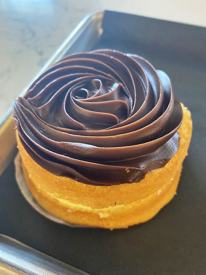 This chocolate-topped delight isn't just dessert—it's architecture. The precision of that frosting swirl would make Frank Lloyd Wright jealous.