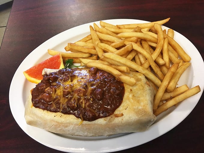 This isn't just a breakfast burrito—it's a commitment. Smothered in chili, flanked by fries, it's the morning meal that might require an afternoon nap.