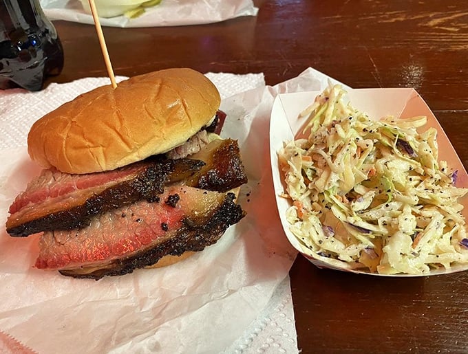 A brisket sandwich with slaw sidekick – the Batman and Robin of Texas lunch options, fighting hunger crimes one bite at time.
