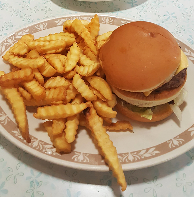 A classic diner burger with crinkle-cut fries—proof that simplicity, when done right, beats culinary gymnastics every time.