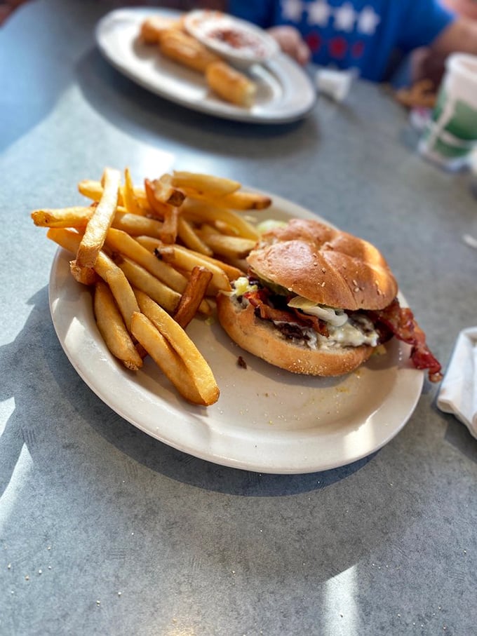 This isn't just a burger—it's a hand-held masterpiece of beef and bun, with fries so golden they'd make Fort Knox jealous.