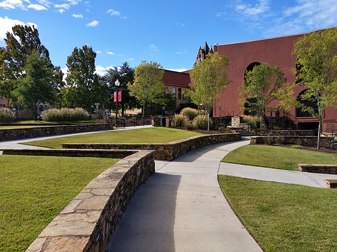 Carolina Wren Park's thoughtful landscaping creates urban green space that invites lingering. Those curved stone walls aren't just decorative—they're impromptu seating for outdoor concerts.