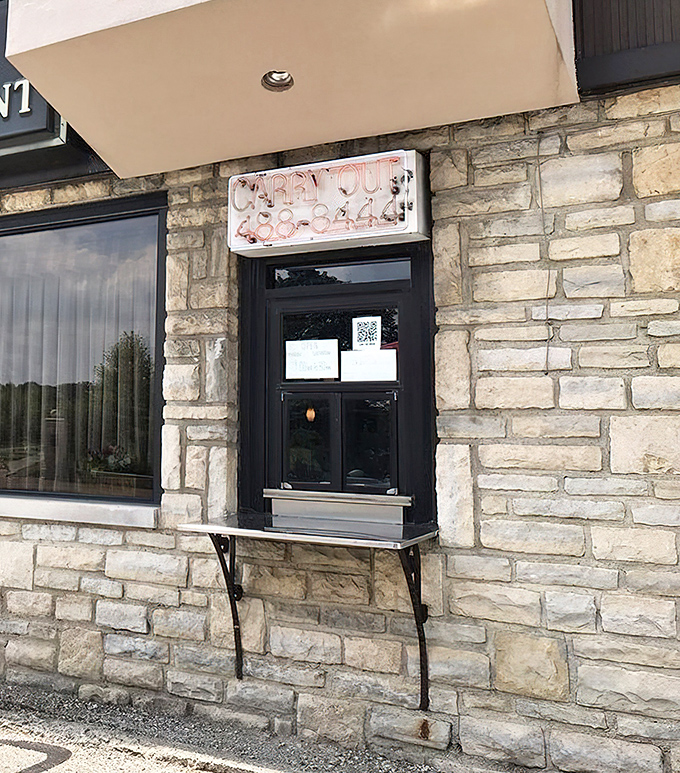 The carry-out window—pandemic-era necessity meets old-school convenience. Drive-thrus existed long before fast food chains claimed them.