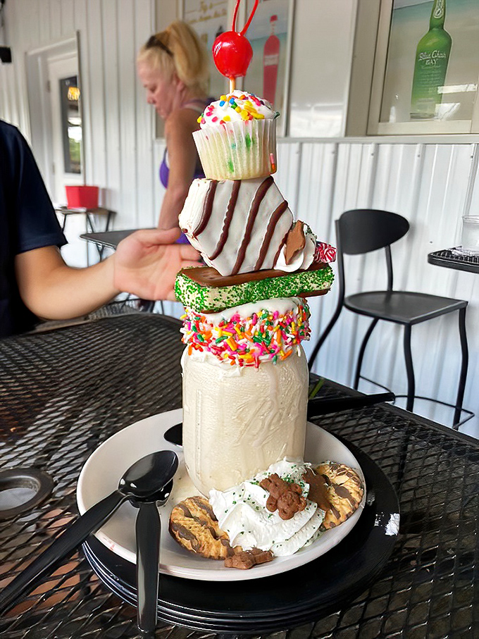 This isn't just a milkshake—it's a towering monument to dessert excess, stacked with cookies, cupcakes, and enough whipped cream to make a dairy farmer blush.